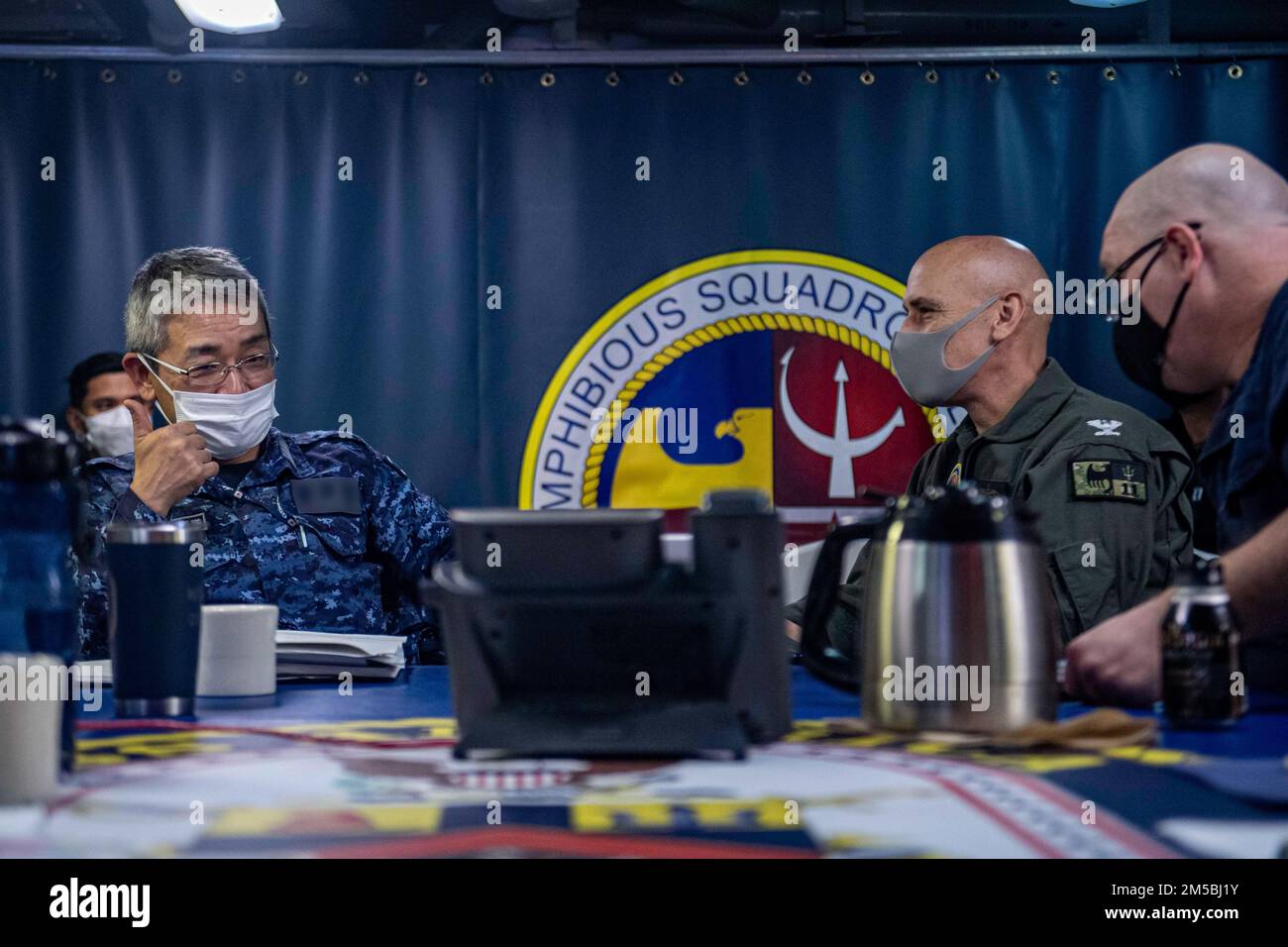 PACIFIC OCEAN (Mar. 7, 2022) Capt. Greg Baker, center right, commodore ...