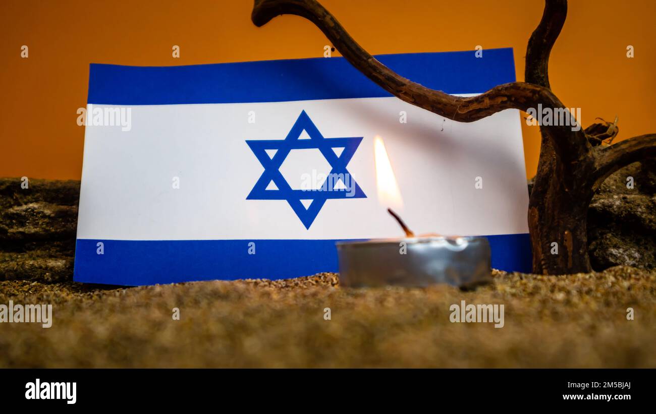 Israeli flag and burning candles in front of it, Holocaust memory day ...