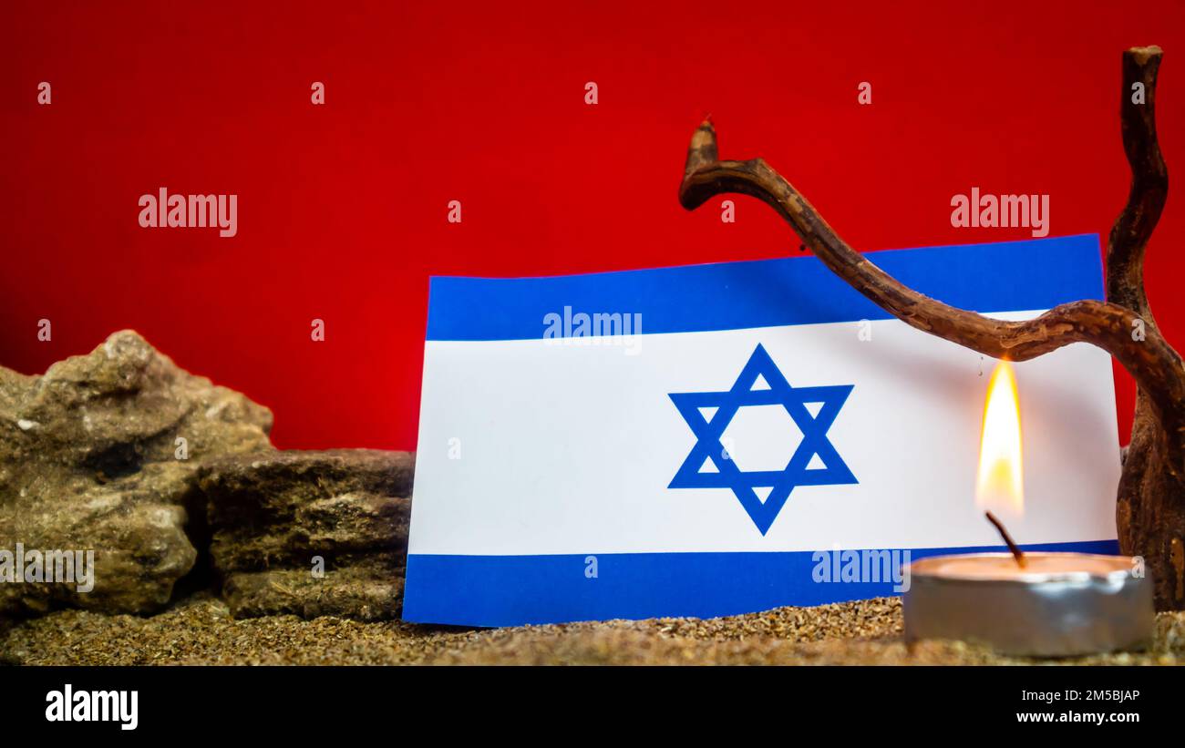 Israeli flag and burning candles in front of it, Holocaust memory day ...