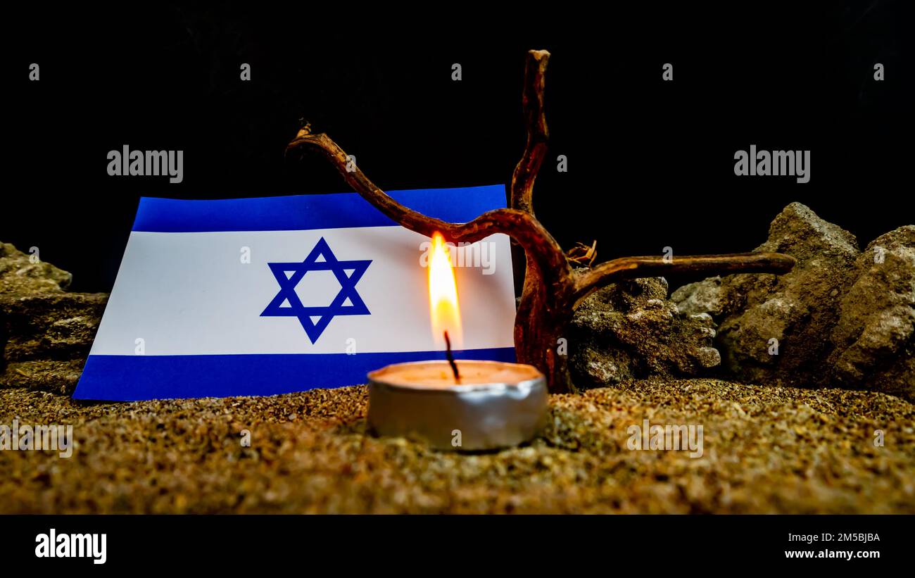 Israeli flag and burning candles in front of it, Holocaust memory day ...