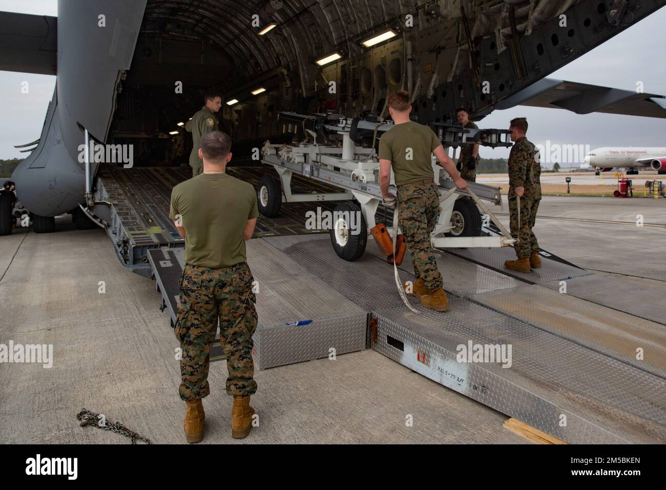U.S. Marines with 2nd Marine Aircraft Wing and U.S. Airmen with 729th Airlift Squadron load a UH ...