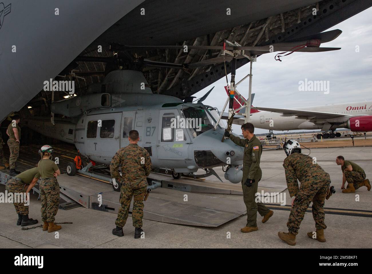 U.S. Marines with 2nd Marine Aircraft Wing and U.S. Airmen with 729th Airlift Squadron load a UH ...