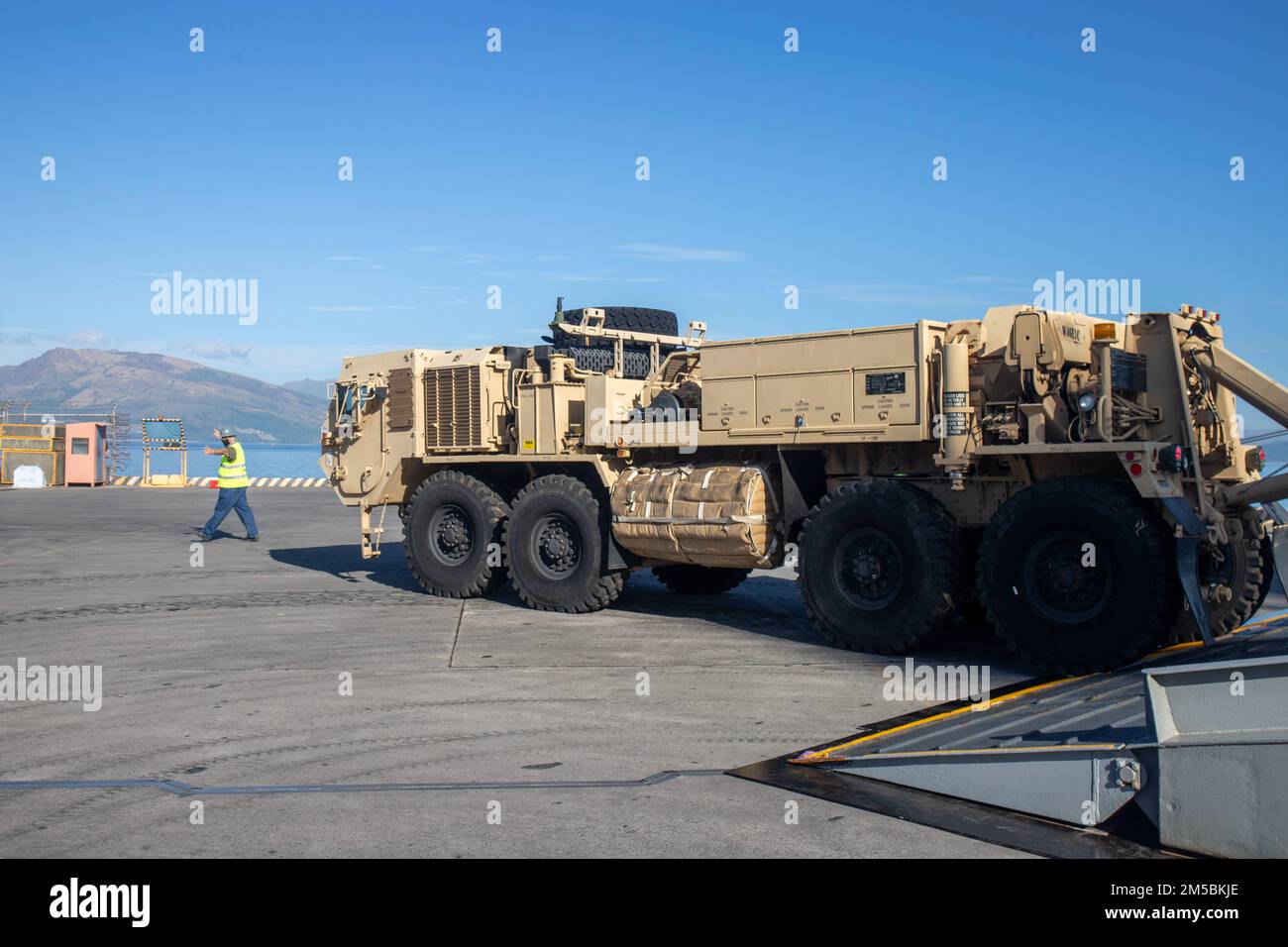 A vehicle is downloaded off the Army Prepositioned Stock-3 vessel, also ...