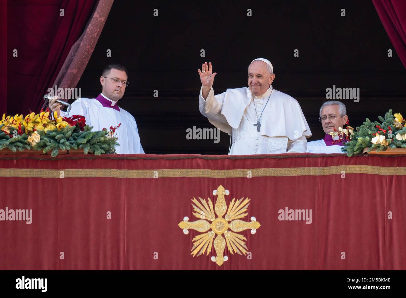 Pope Francis waves from the balcony of St Peter's basilica overlooking ...