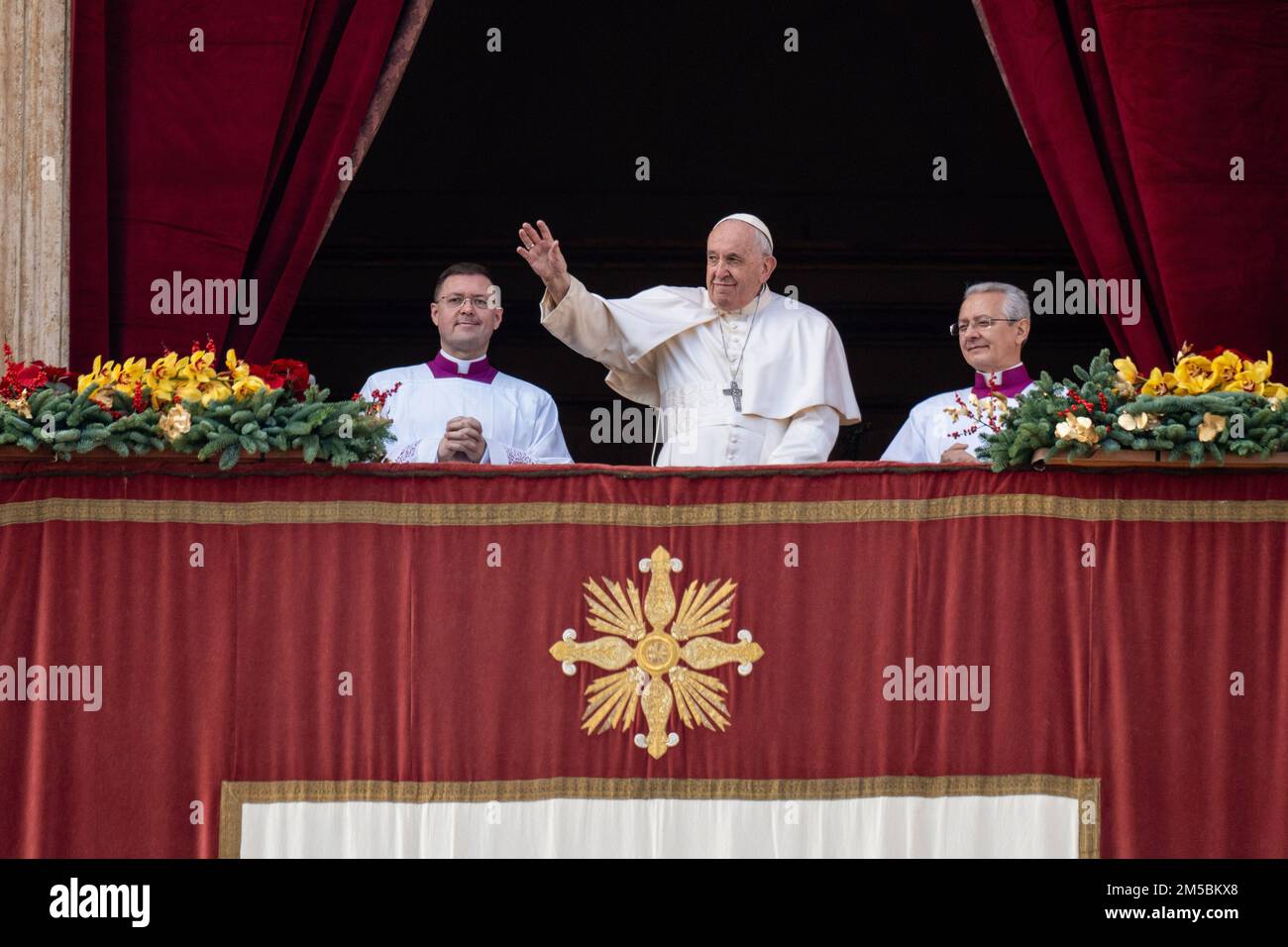 Pope Francis waves from the balcony of St Peter's basilica overlooking ...