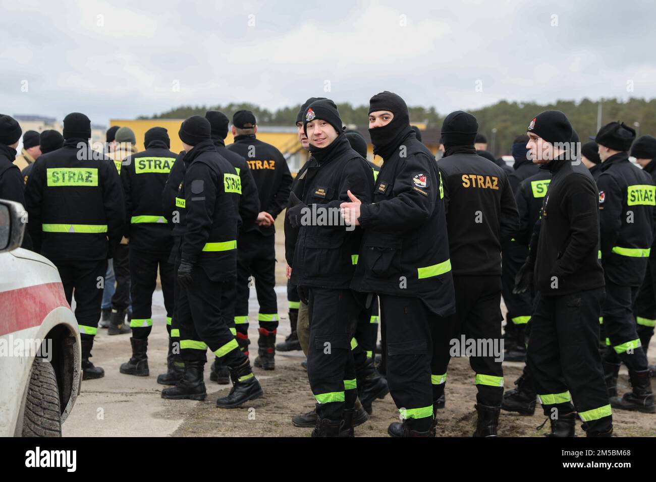 Polish firefighter cadets give a thumbs up as they walk past the wash ...