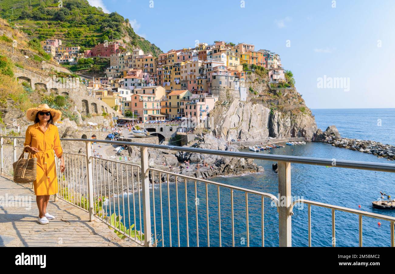 Asian women with a hat visiting Manarola Village Cinque Terre Coast ...