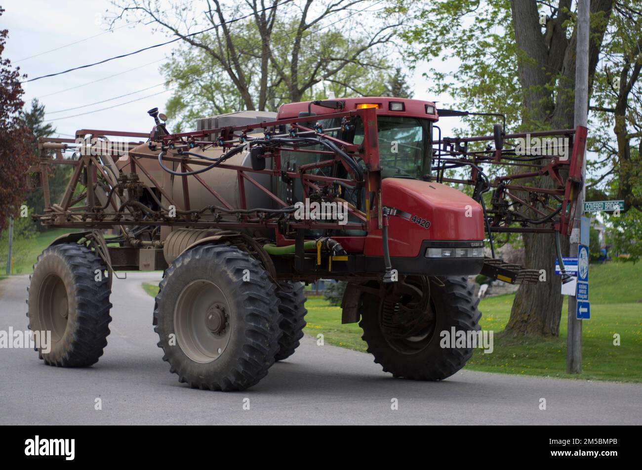 rustic large farm machine driving on farm road Stock Photo - Alamy
