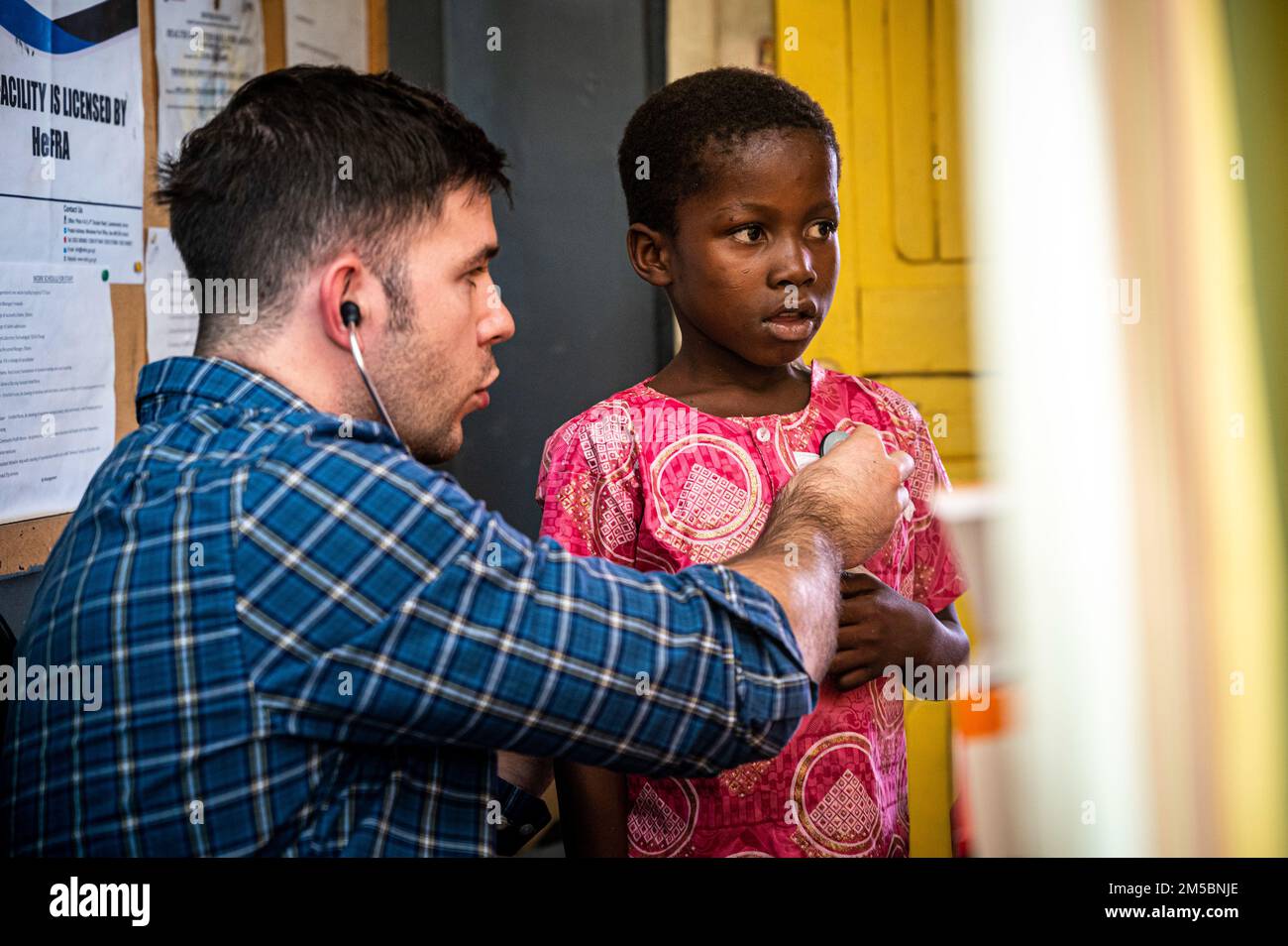A U.S. Army Civil Military Support Element medic checks the lungs of a ...
