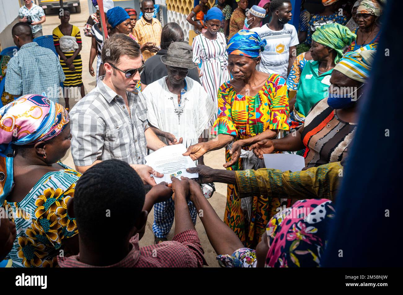 A U.S. Army Civil Military Support Element member hands out surveys to ...