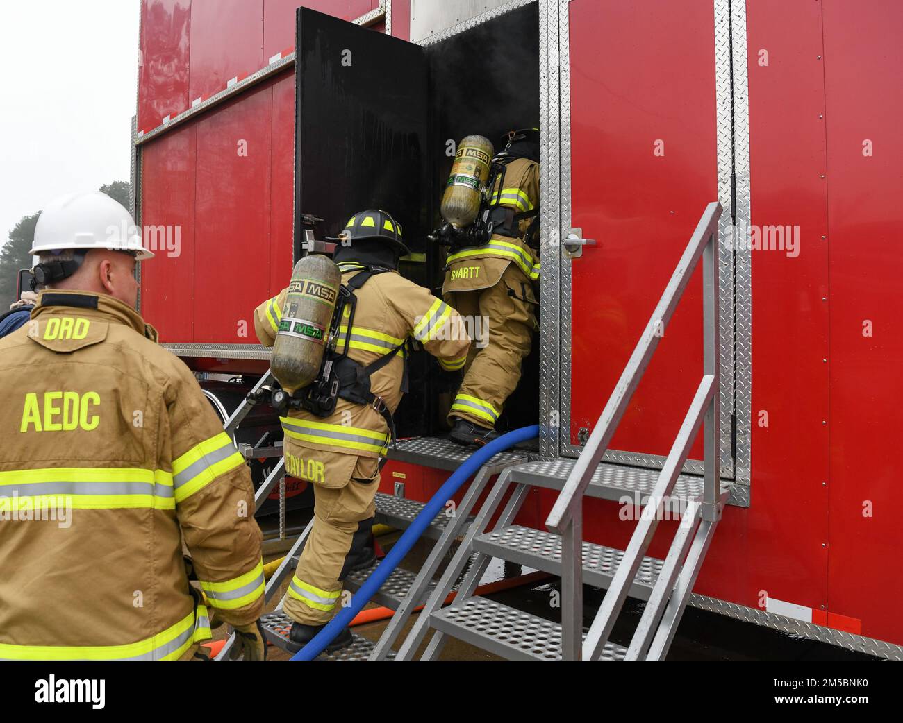 Arnold Air Force Base firefighters enter a trailer designed to simulate ...
