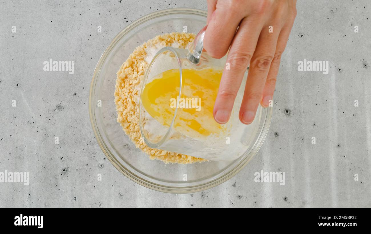 Cracker crust for cheesecake recipe. Mixing crushed crackers with ...