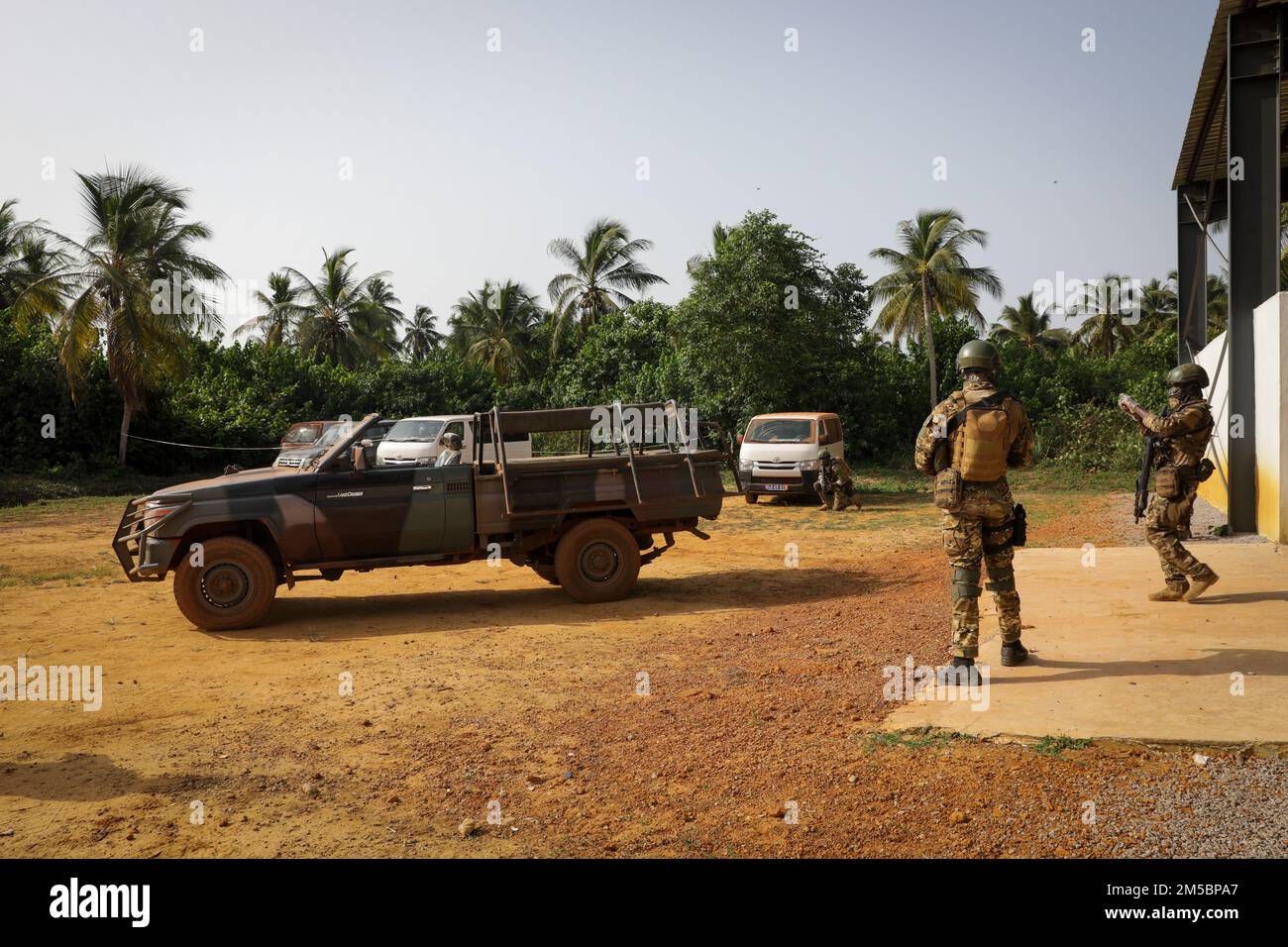 A Côte d'Ivoire Special Forces Soldier takes photos of an enemy vehicle ...
