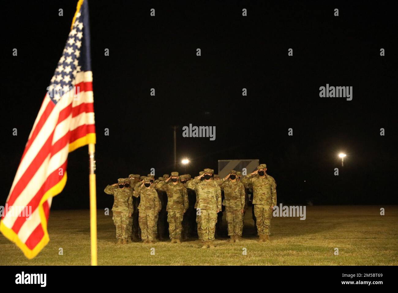 3rd Division Sustainment Brigade Soldiers salute the national colors ...