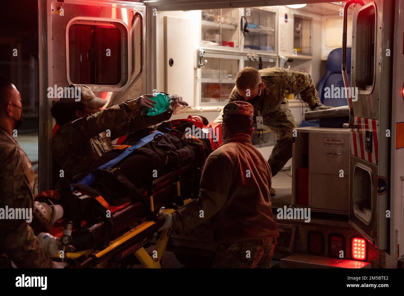 U.S. Air Force Airmen assigned to the 51st Medical Group, load a ...