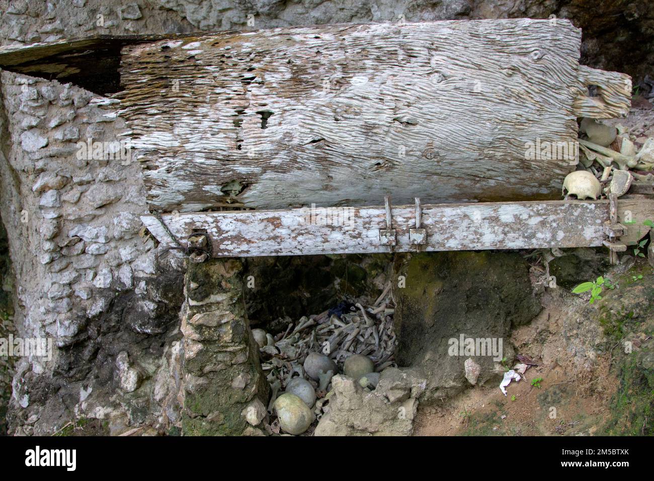 The wooden graves placed in and around the cave are part of the customs ...
