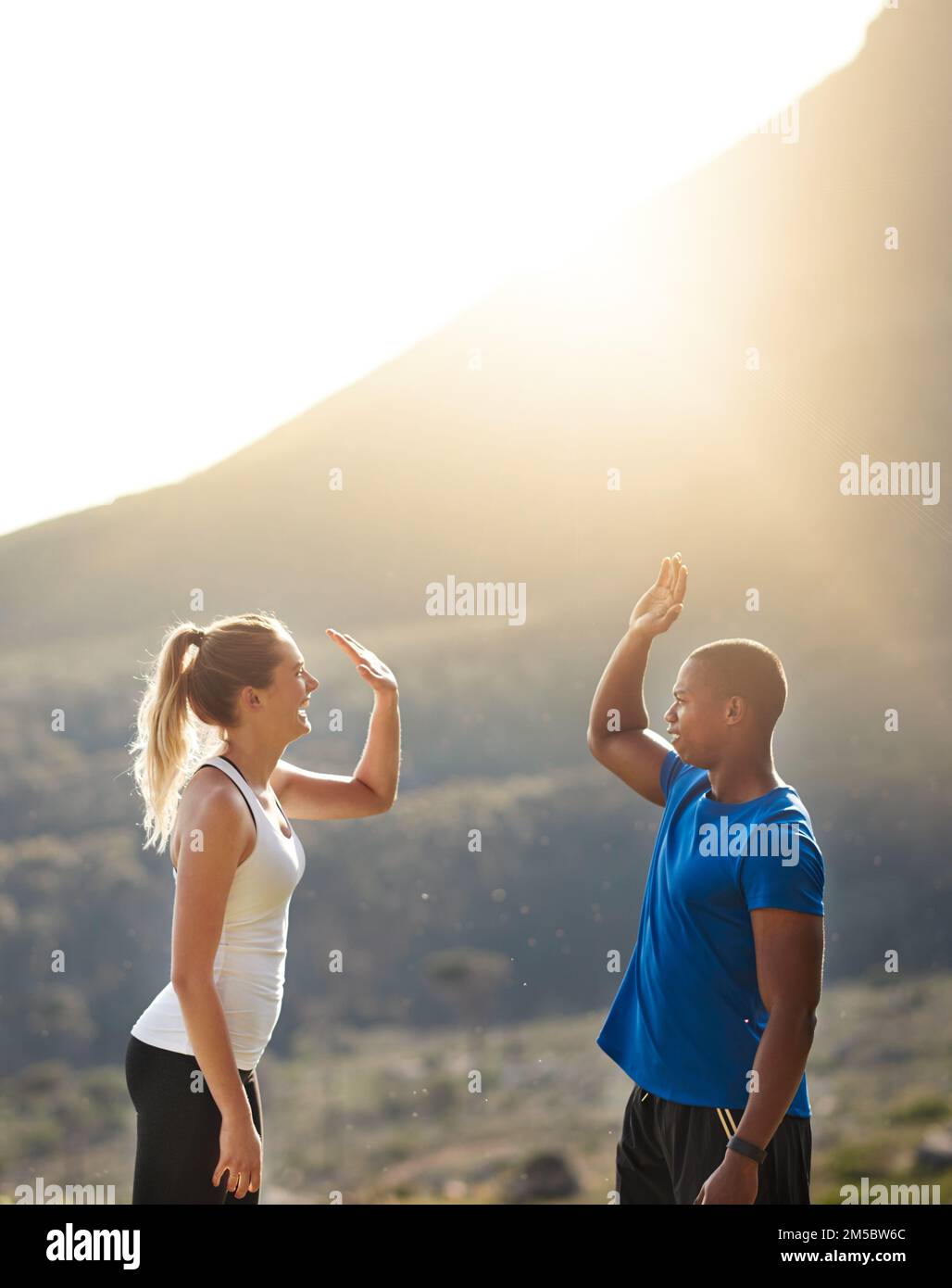 Surround yourself with great positive people. a sporty couple high ...