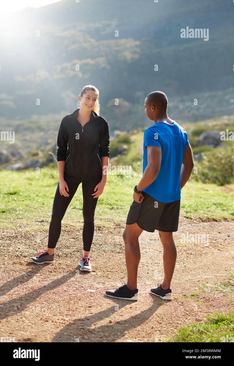 Run in places you love with people you love. two athletes chatting ...