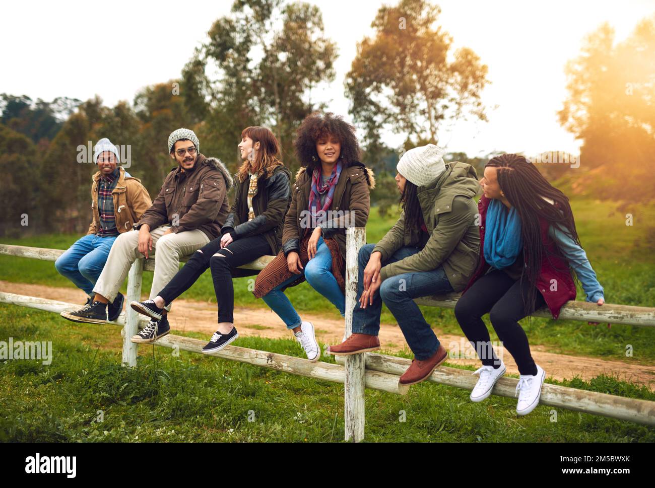 Bonding in the great outdoors. a happy group of friends sitting in a ...