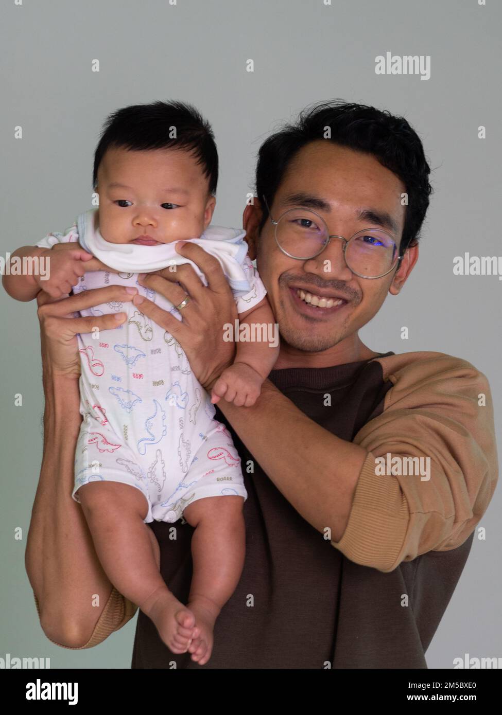 Man and baby Asian and nationality Thai is happy feel Stock Photo - Alamy