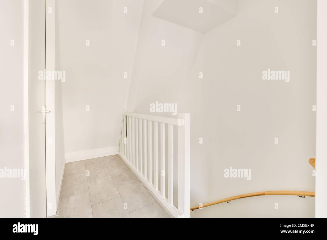 an empty room with white walls and wood railings on either side, there ...