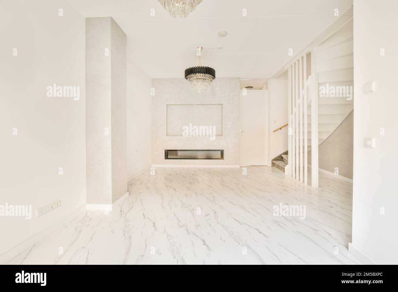 an empty living room with marble flooring and white walls there is a ...