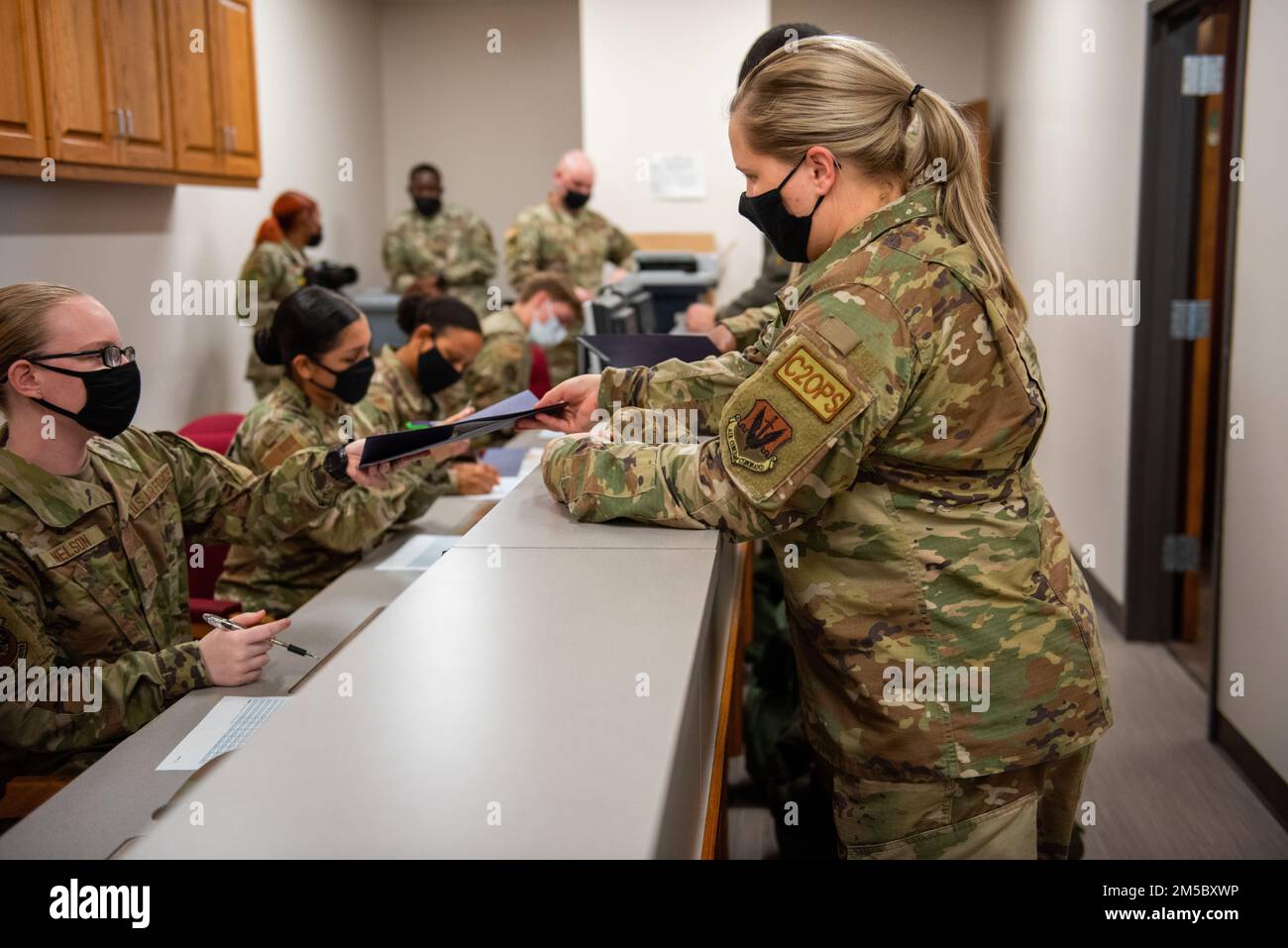 The Deployment Control Center staff processes Airmen through the pre ...