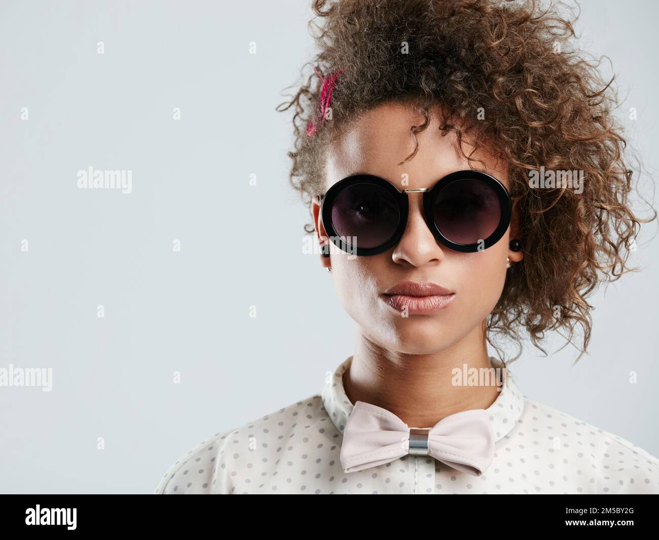 Sunglasses add that instant cool factor. Studio portrait of a ...