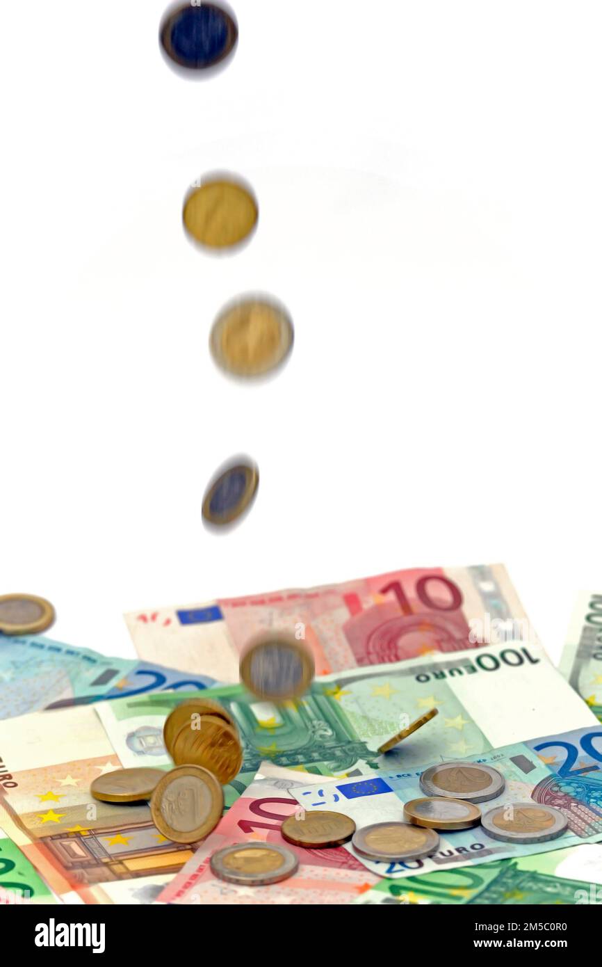 Euro coins fall on euro banknotes, rain of money, high cost, symbolic ...