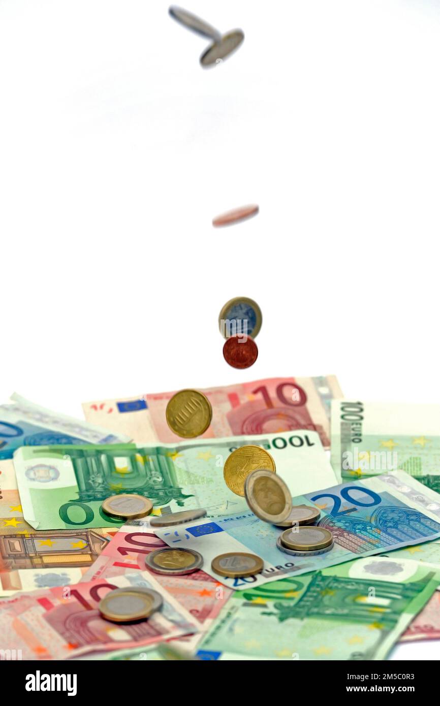 Euro coins fall on euro banknotes, rain of money, high cost, symbolic ...