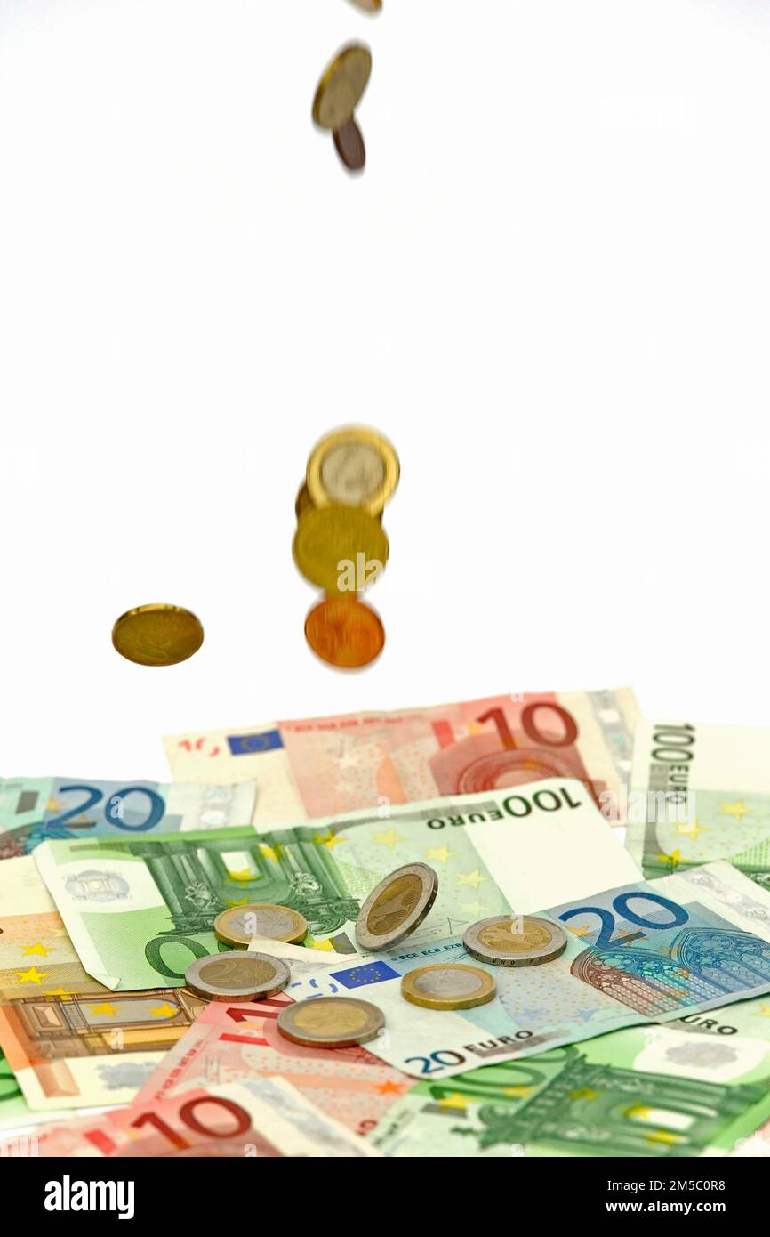 Euro coins fall on euro banknotes, rain of money, high cost, symbolic ...