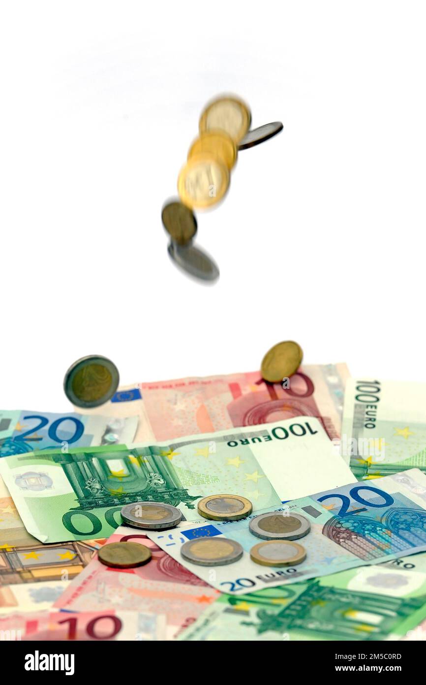 Euro coins fall on euro banknotes, rain of money, high cost, symbolic ...