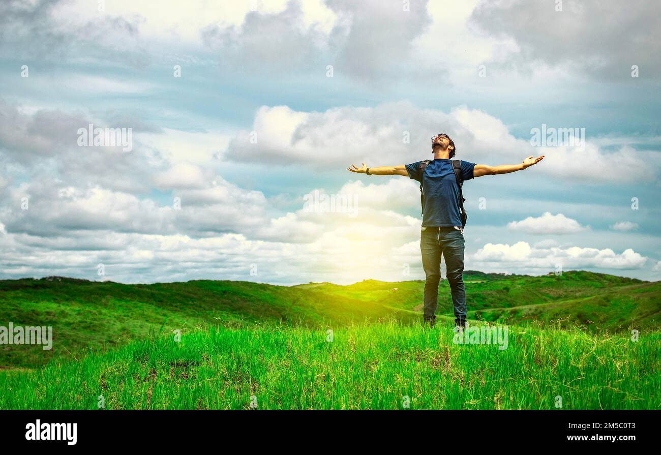 Adventurous man spreading his arms in the countryside. Man with ...