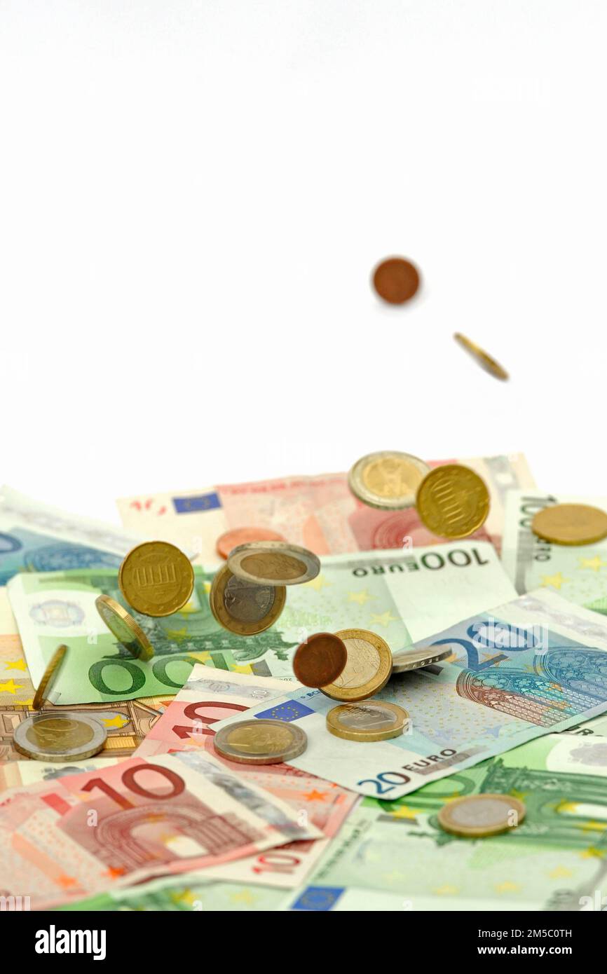 Euro coins fall on euro banknotes, rain of money, high cost, symbolic ...