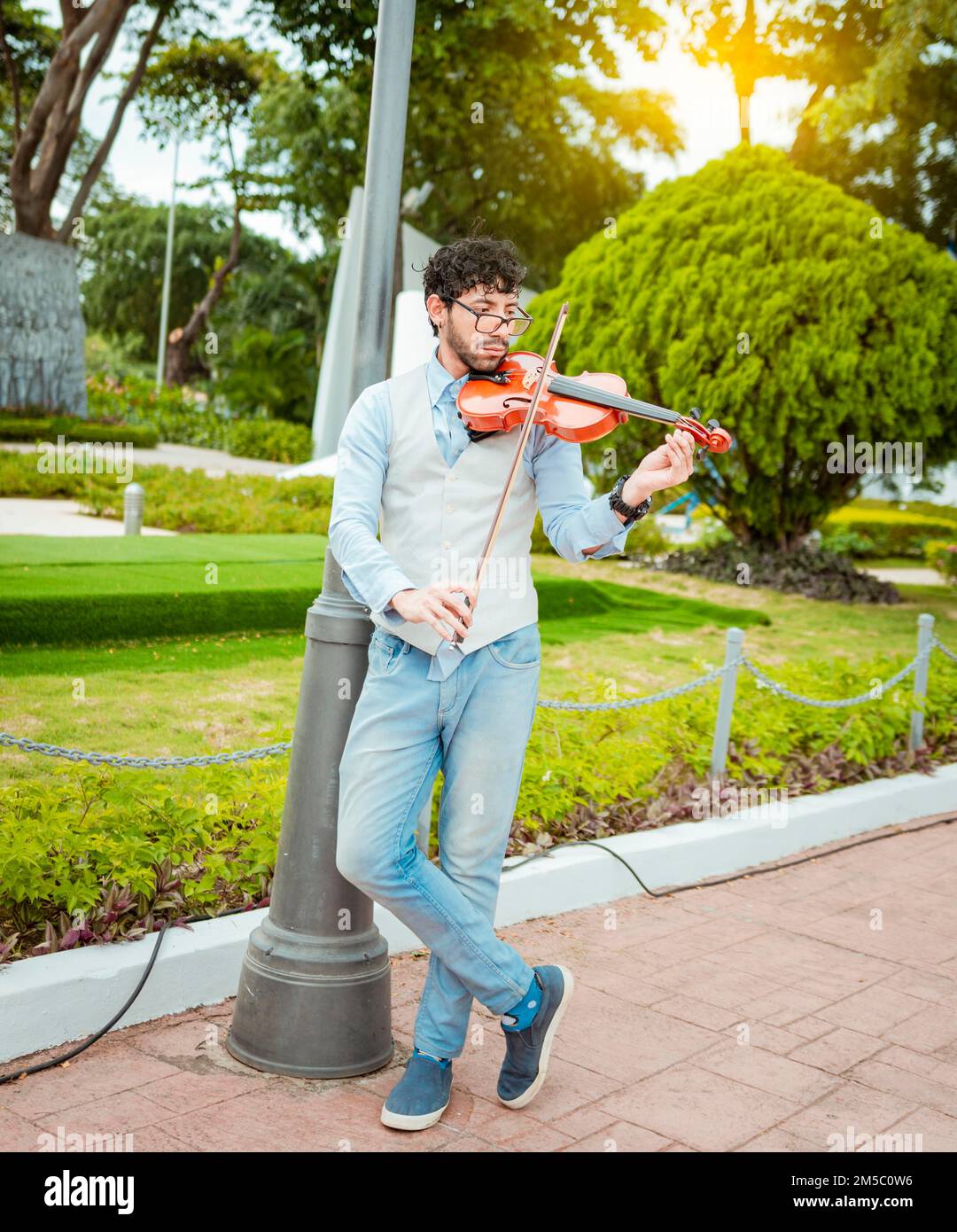 Portrait of man playing violin in the street. Jacket artist playing ...