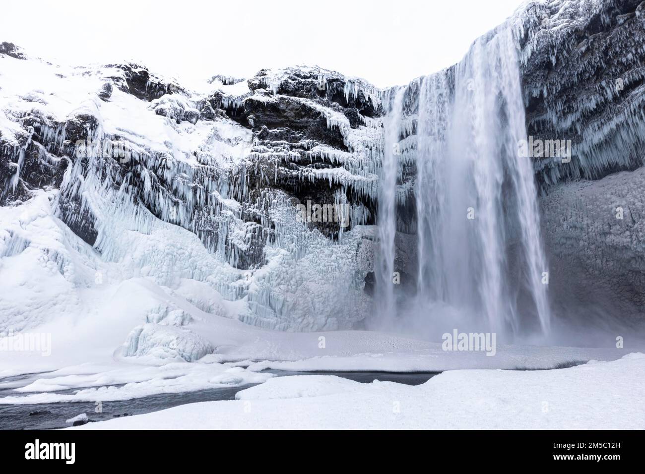 Skogafoss waterfall, snowy and icy rock face, Sudurland, Iceland Stock ...