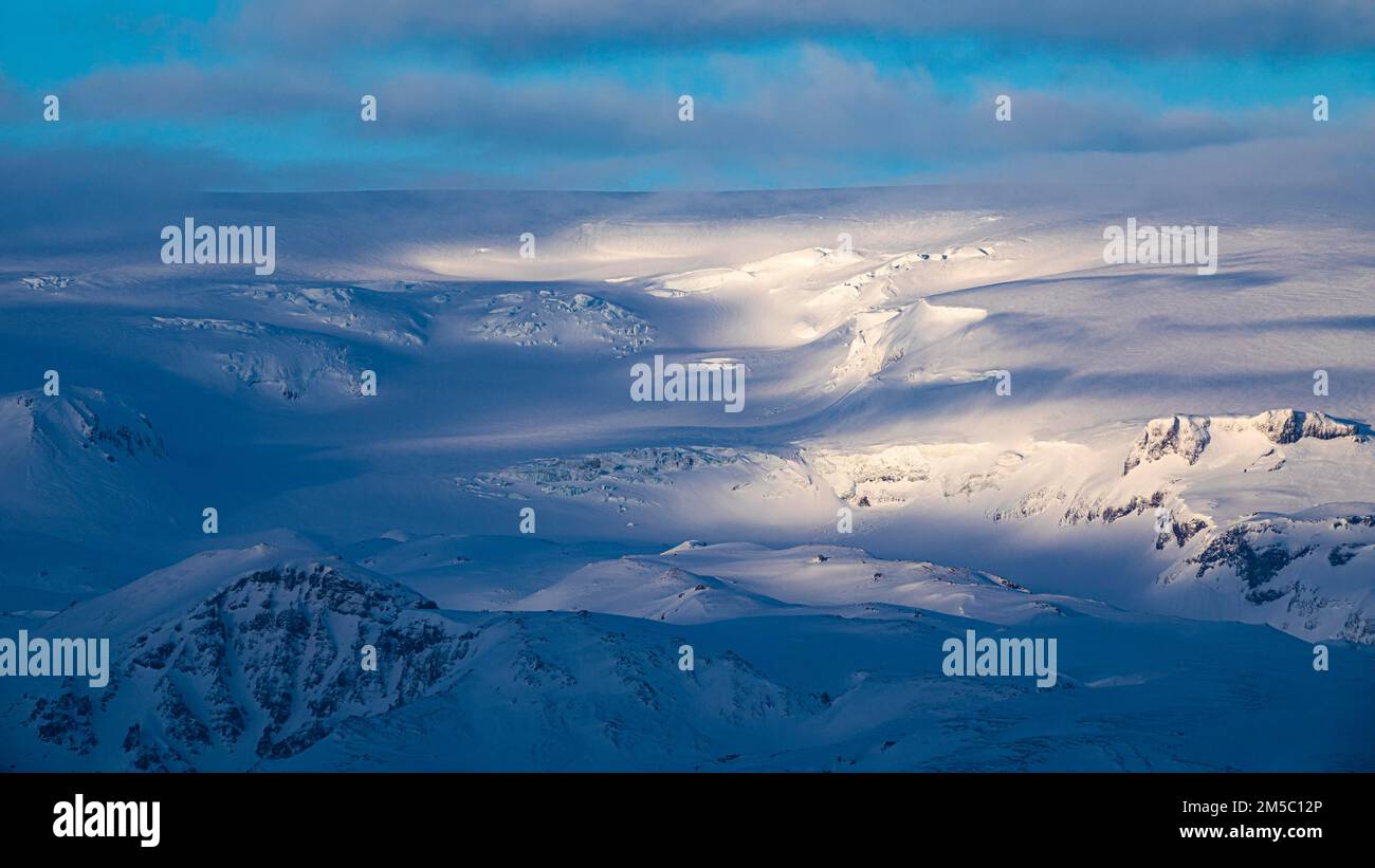 Light and shadow over the snowy hills and mountains of Myrdalsjoekull ...