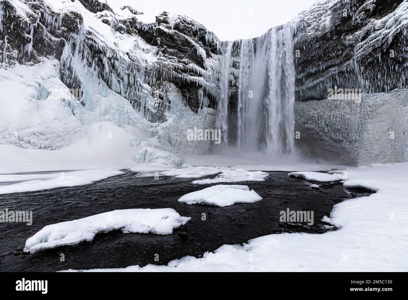 Skogafoss waterfall, snowy and icy rock face, Sudurland, Iceland Stock ...