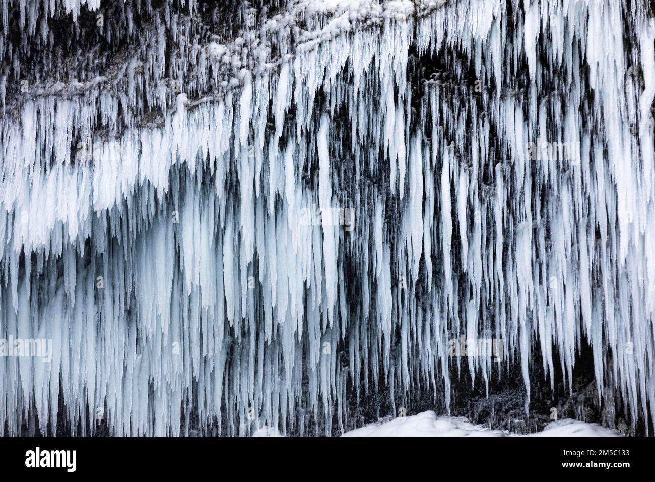 Icicles on the rock face at Skogafoss waterfall, Sudurland, Iceland ...