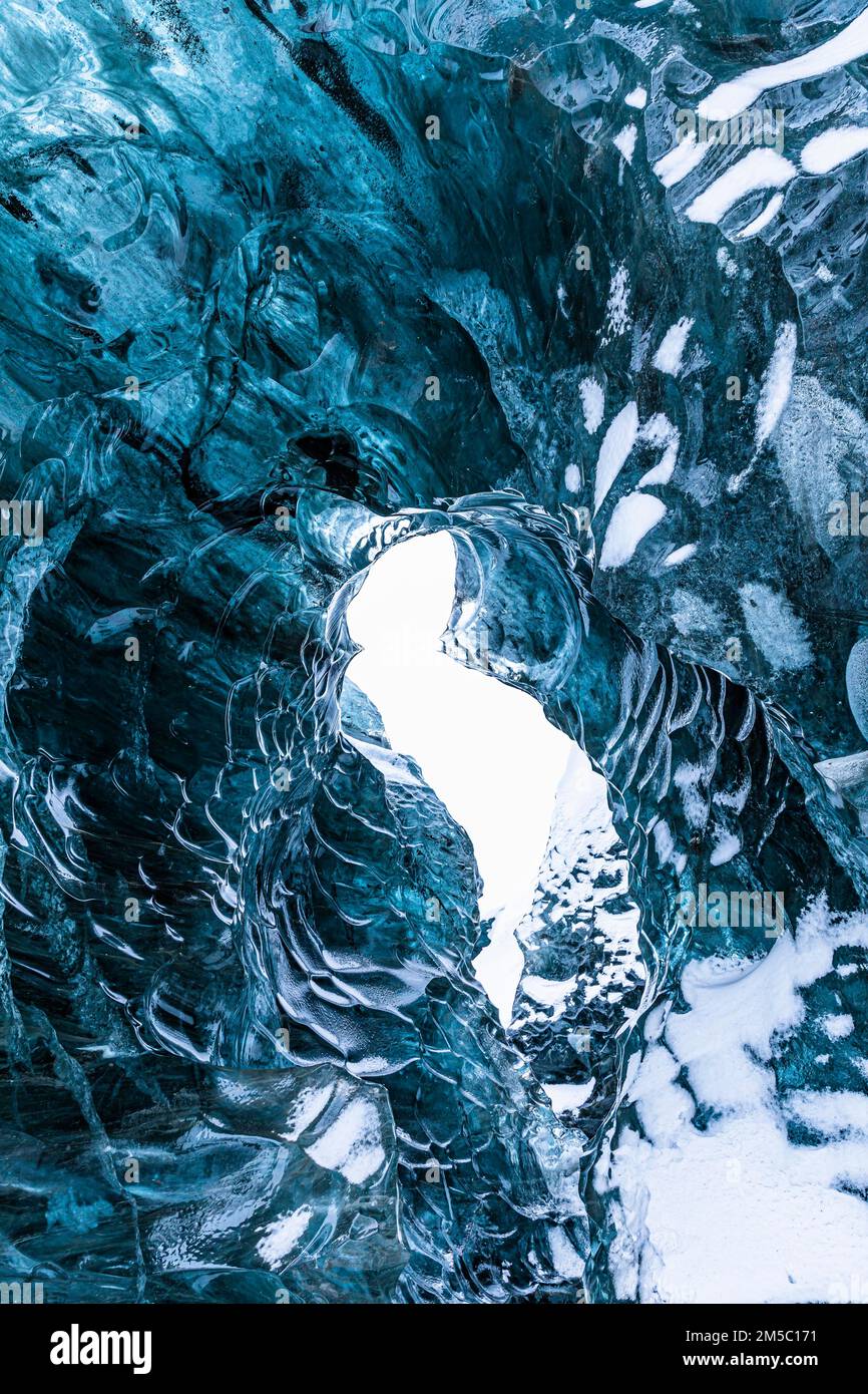 Ice cave open to the top with snow-covered ice combs, Proeng ice cave ...