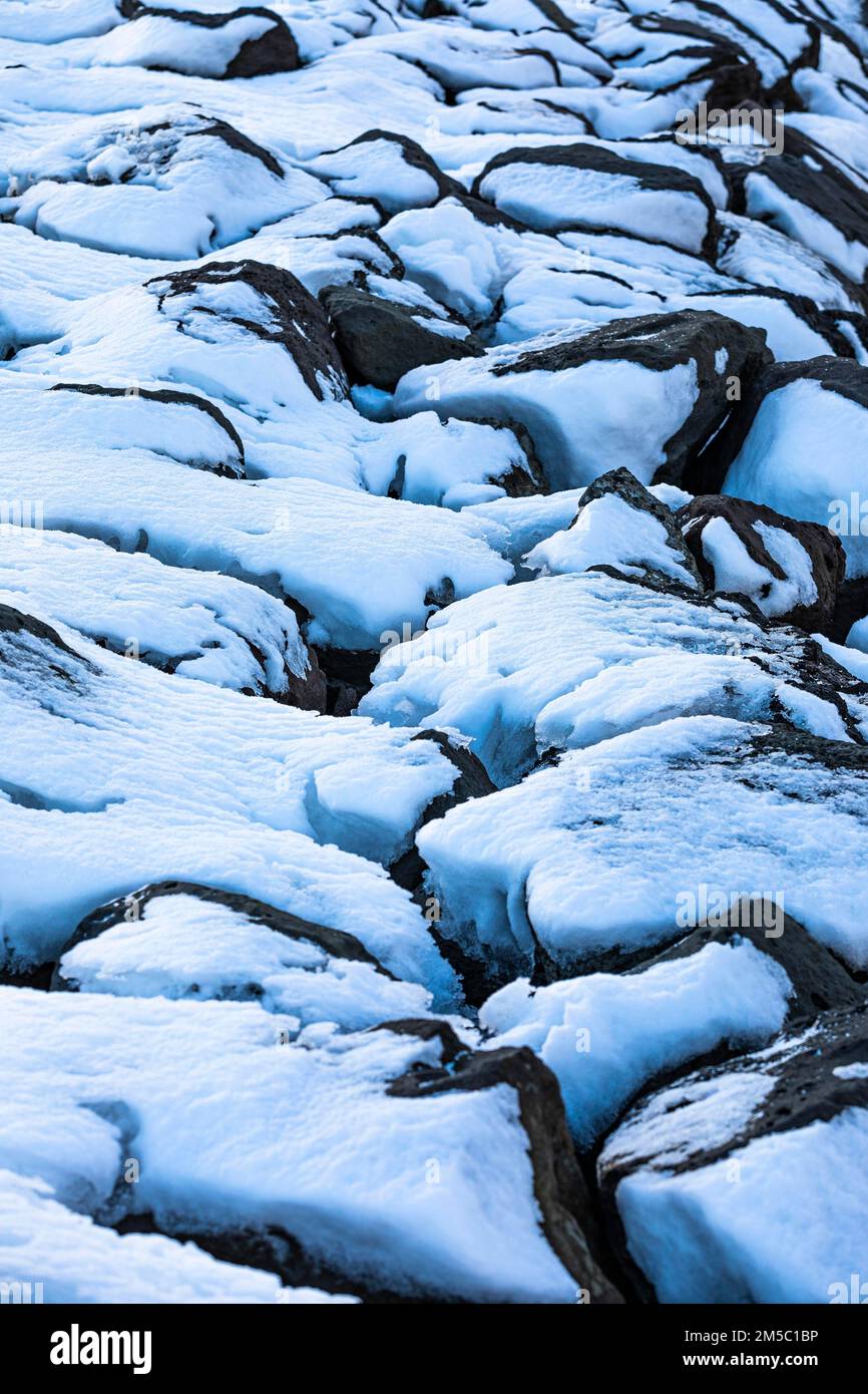 Snow-covered rocks at the harbour of Reykjavik, Reykjanes Peninsula ...