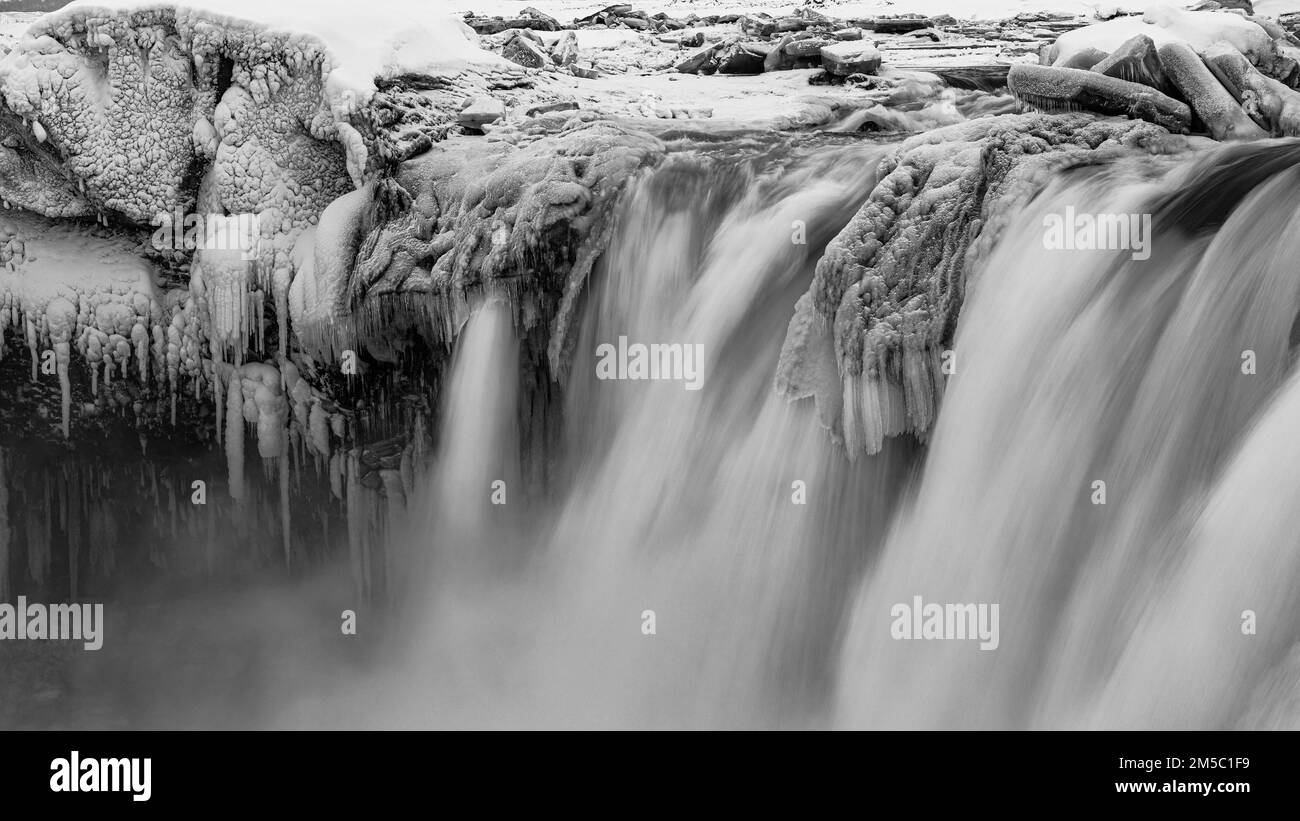 Godafoss waterfall, icy and snowy rock face, black and white photo ...
