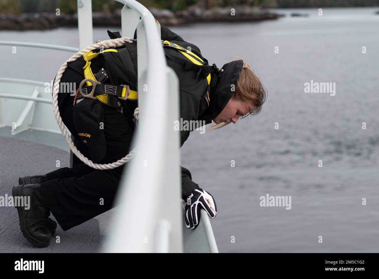 Sailor First Class Ryane Szajcz inspects the cable of the anchor on ...