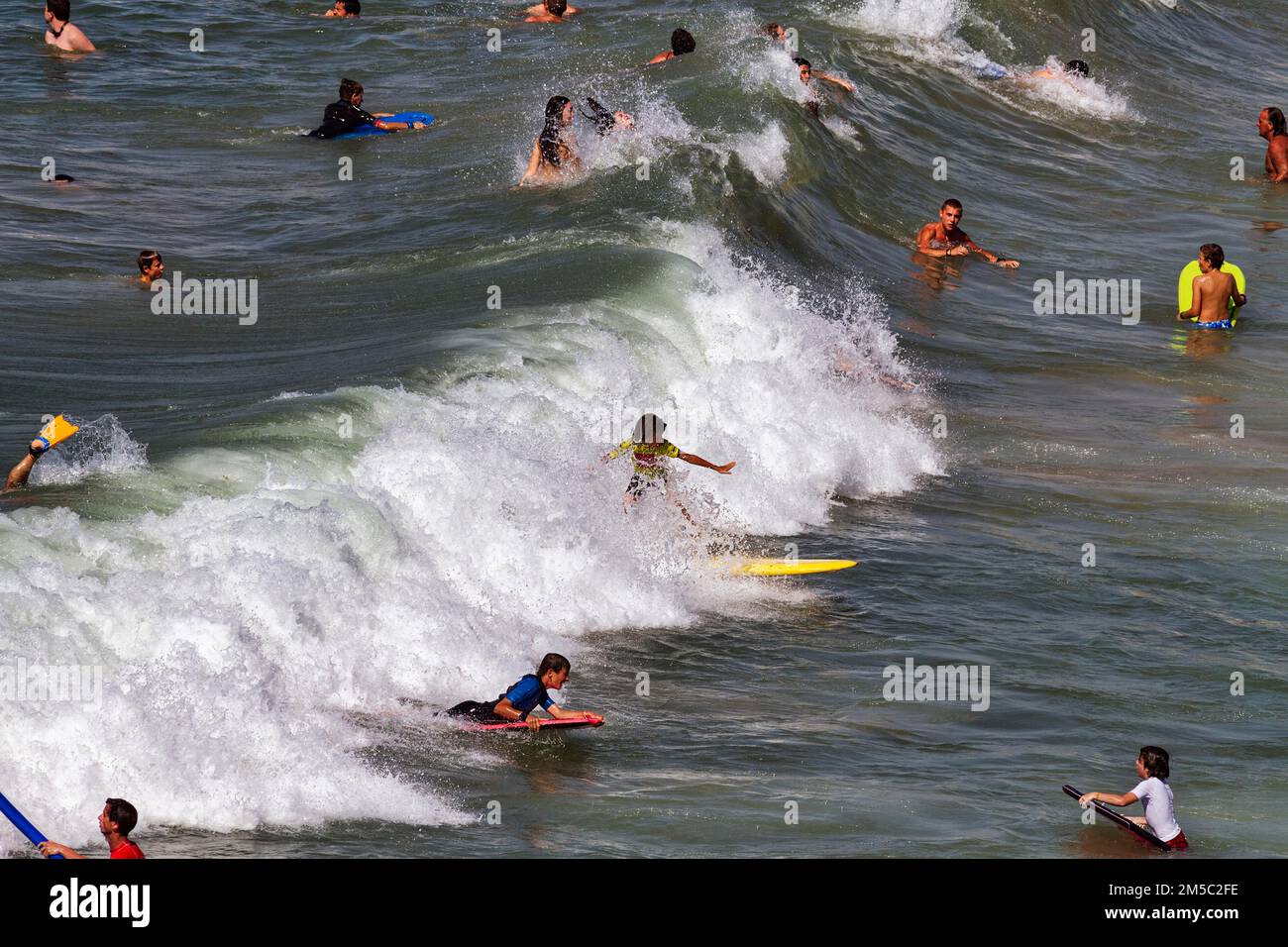 View from above on crowd, tourists surfing, swimming in the sea ...