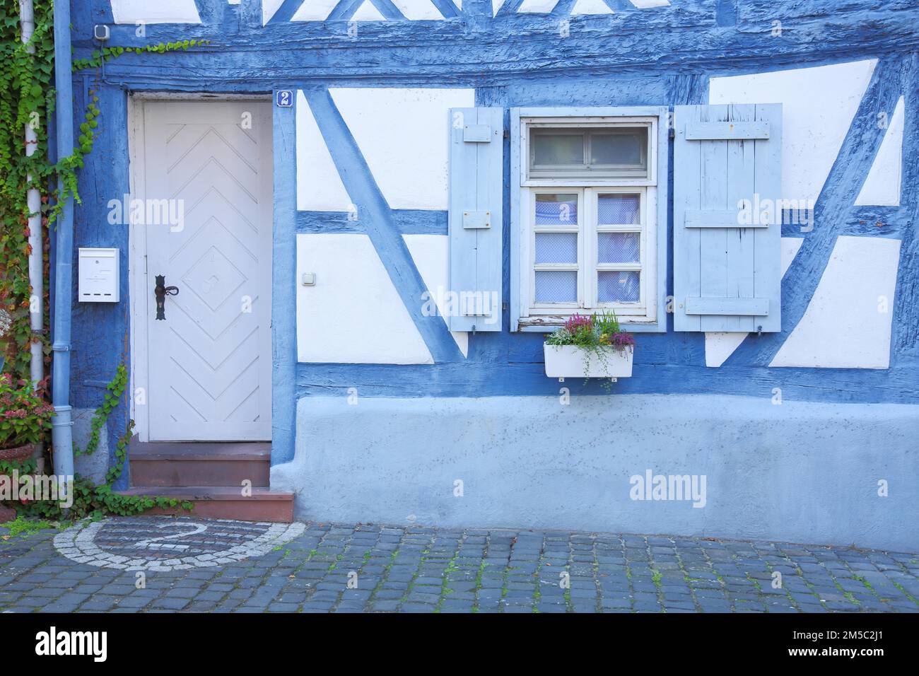 Half-timbered house with floor mosaic as house number 2, two and window ...