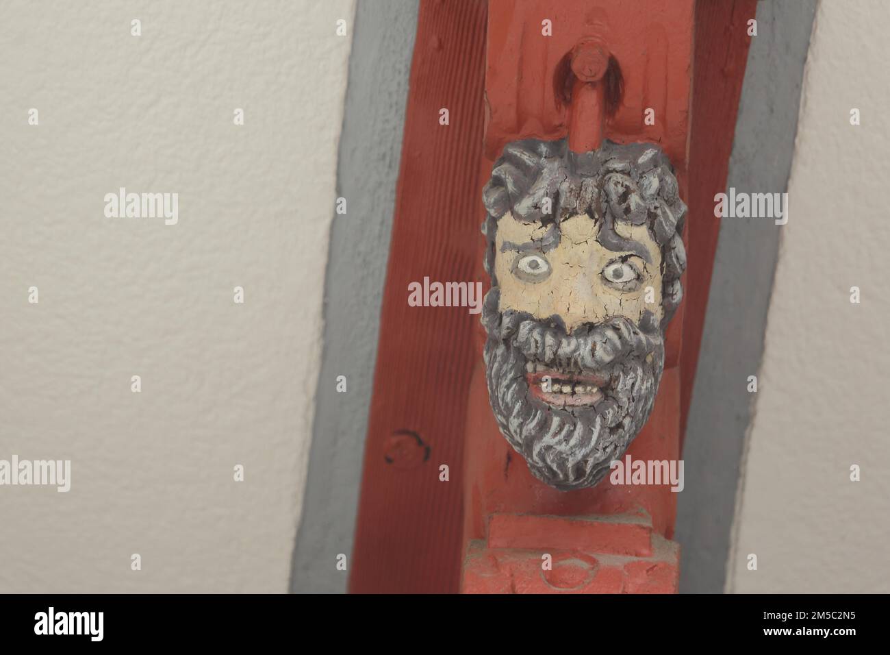 Grimace on half-timbered house, detail, figure, face, head, horrible ...