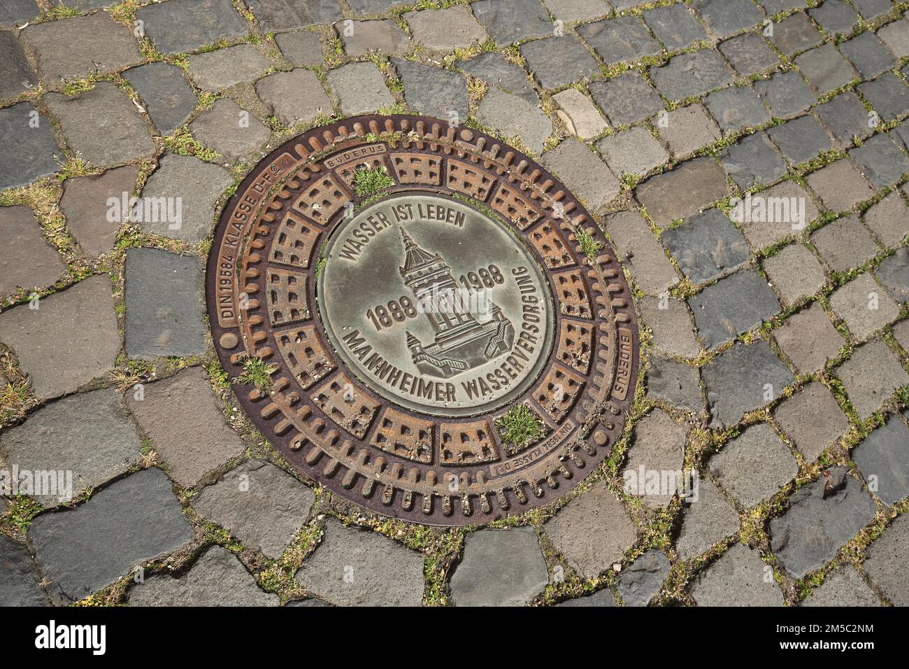 Manhole cover with inscription Water is life and water tower as ...