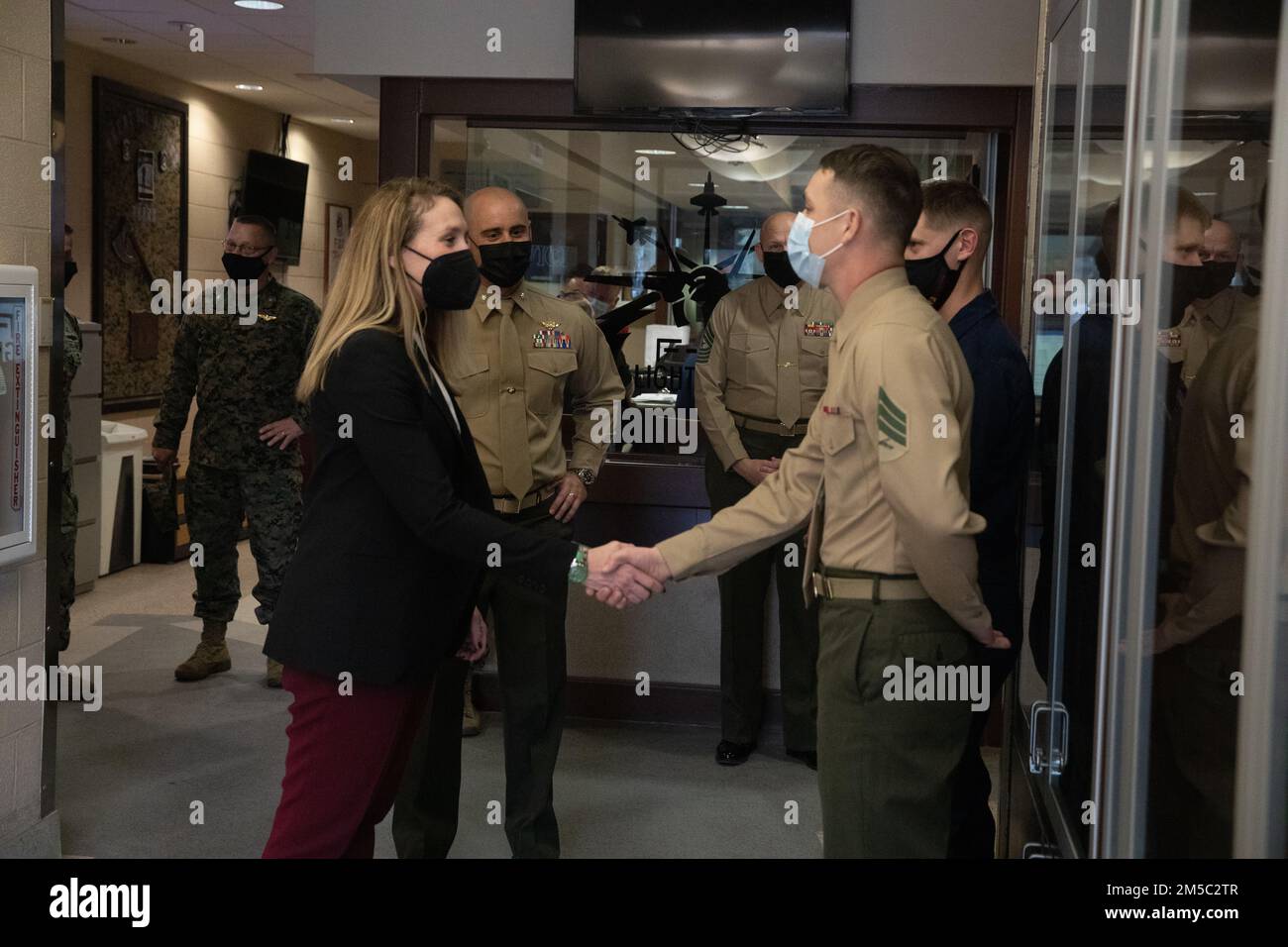 The Honorable Meredith A. Berger, Under Secretary of the Navy, shakes ...