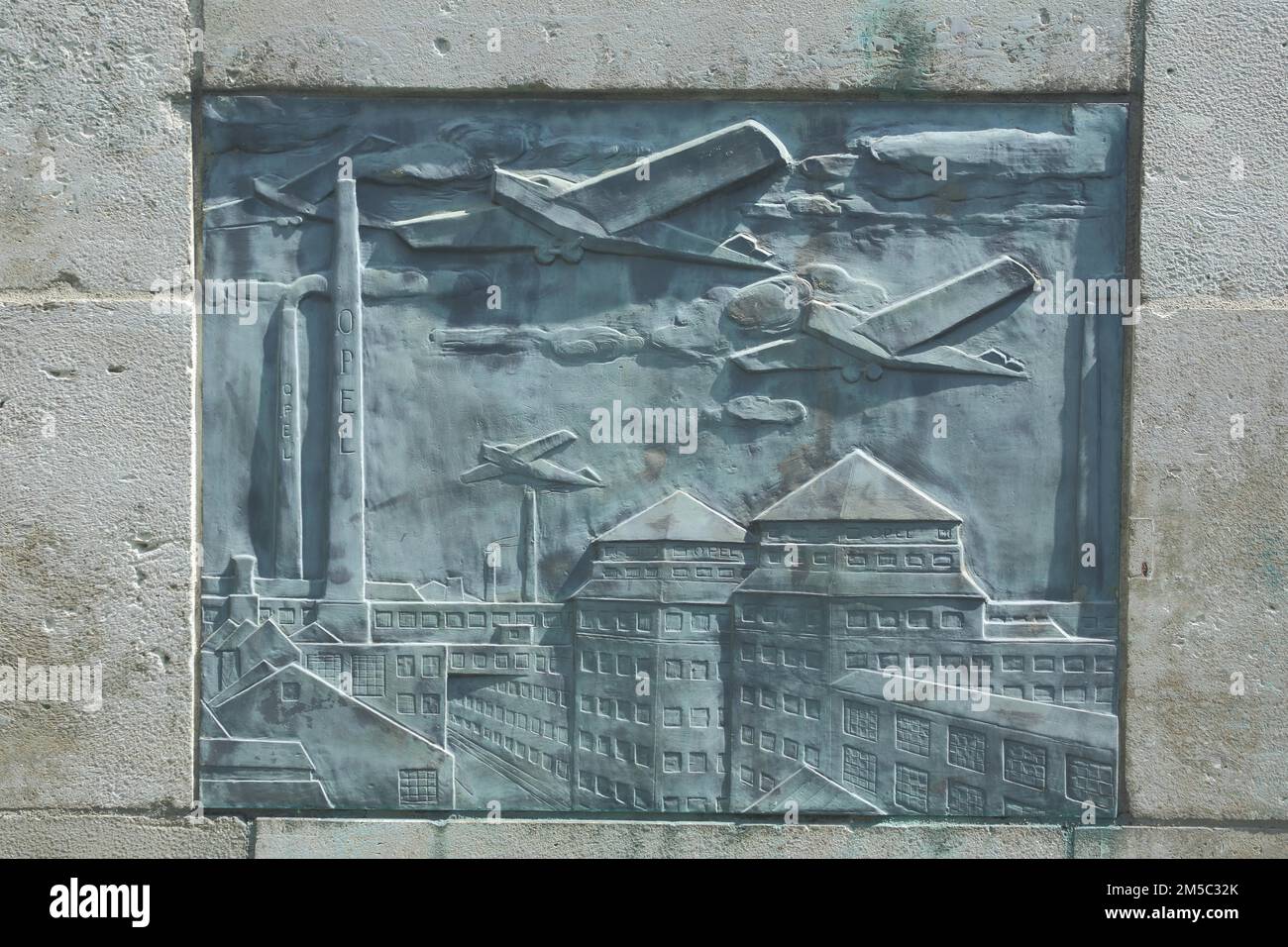 Relief on war memorial with scene of air raid with aircraft during ...