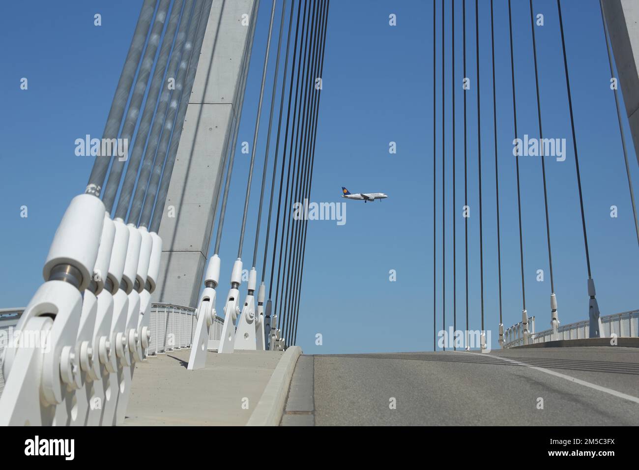 Cable-stayed bridge with passenger aircraft approaching Frankfurt, Main ...
